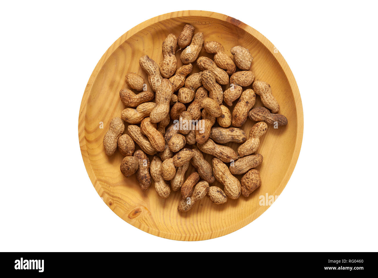 Unpeeled peanuts in a wooden pine plate on a white isolated background ...