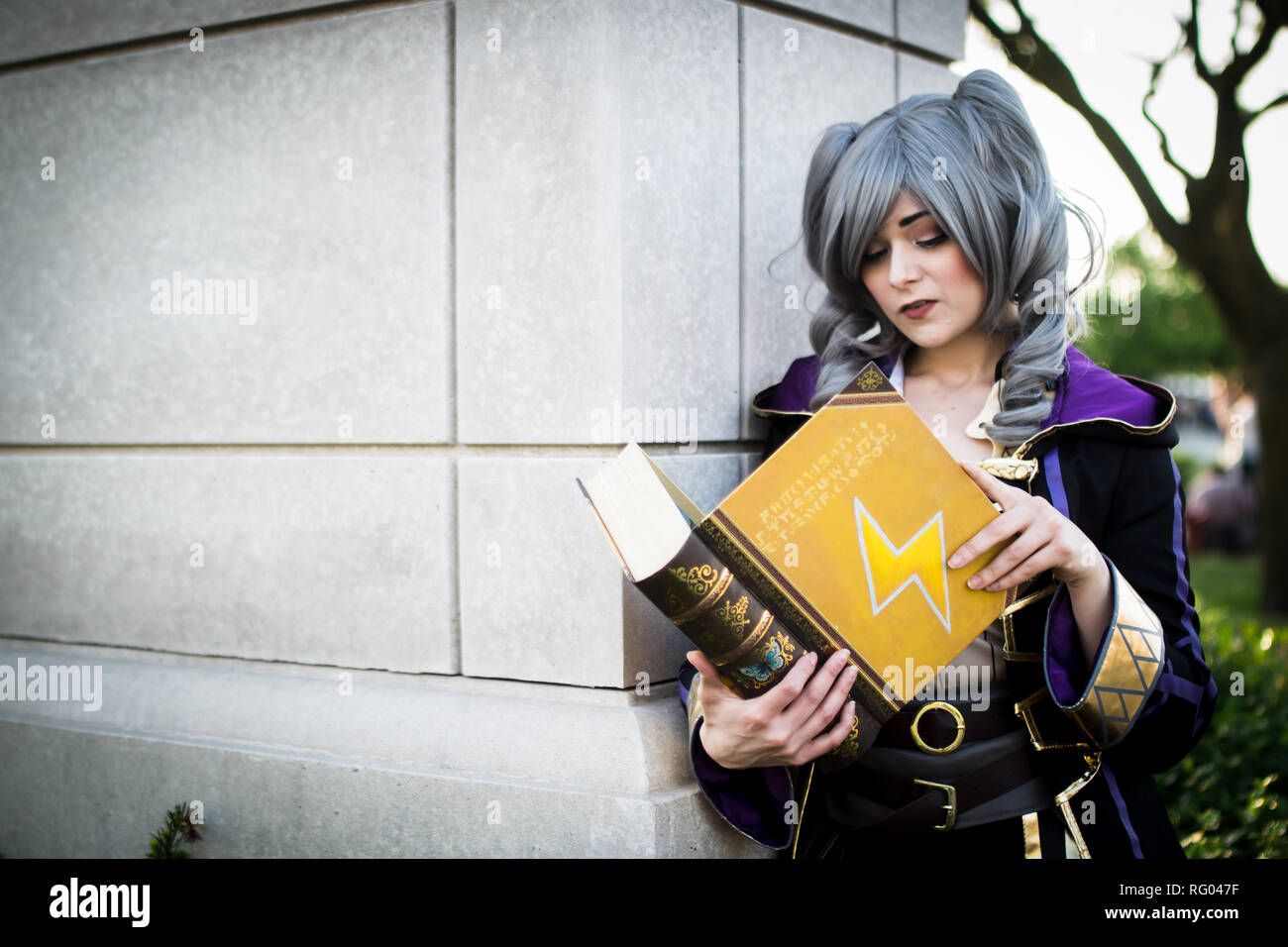 Magic girl cosplay, gray hair, clean brick wall Stock Photo - Alamy