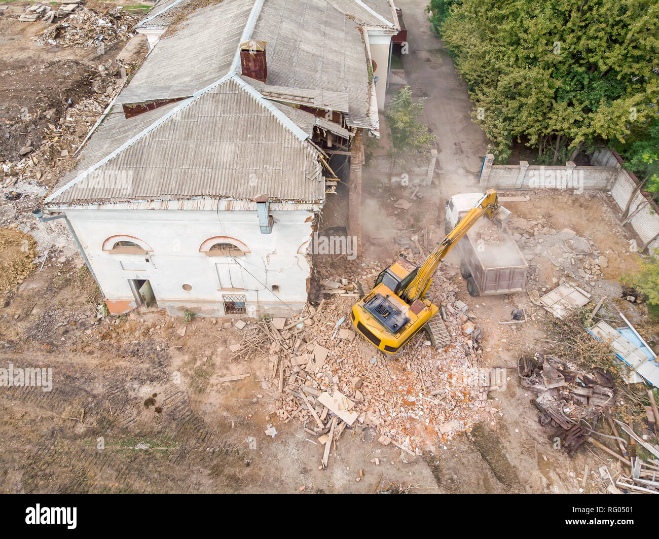top view of industrial machinery working at demolition site in garbage ...