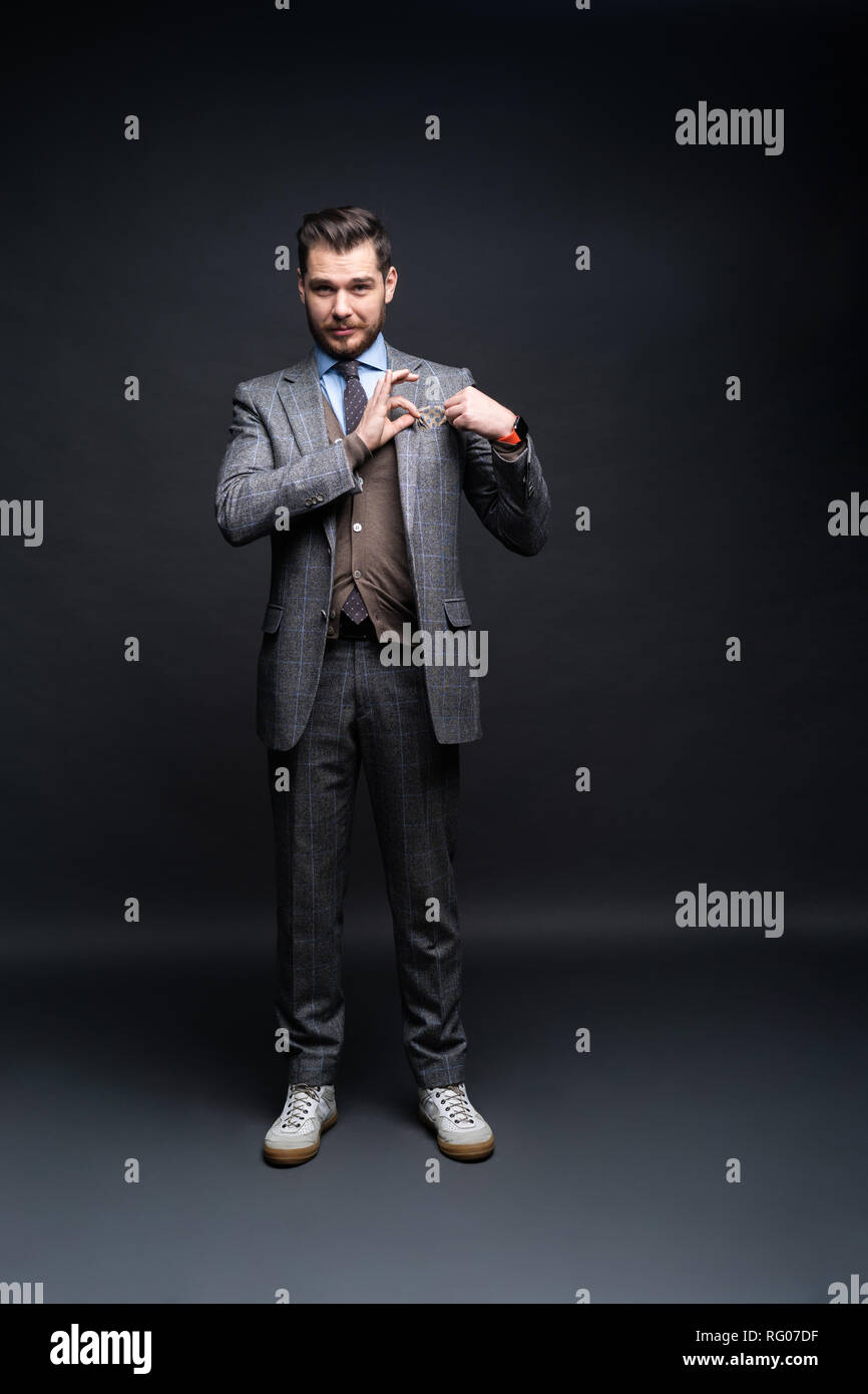 Full length portrait of a fashion male model over black background ...