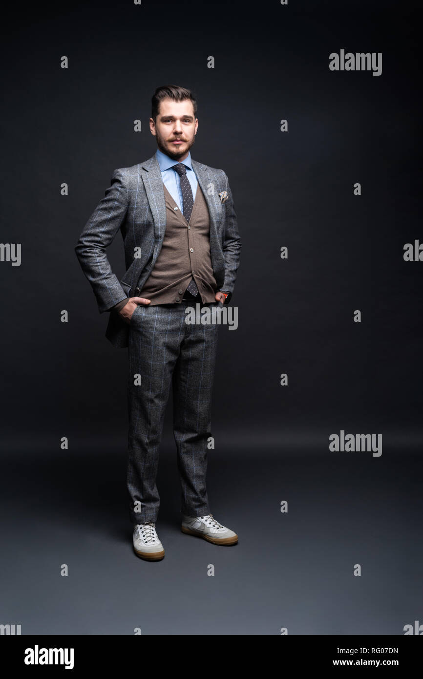 Full length portrait of a fashion male model over black background ...