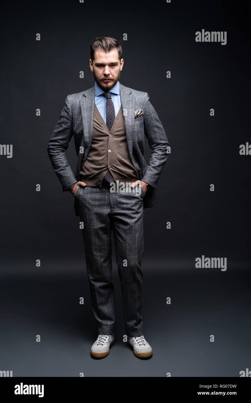 Full length portrait of a fashion male model over black background ...