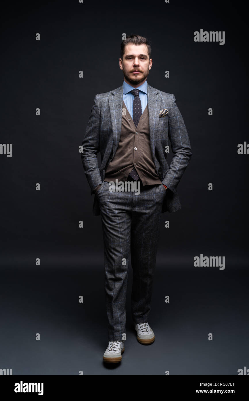 Full length portrait of a fashion male model over black background ...