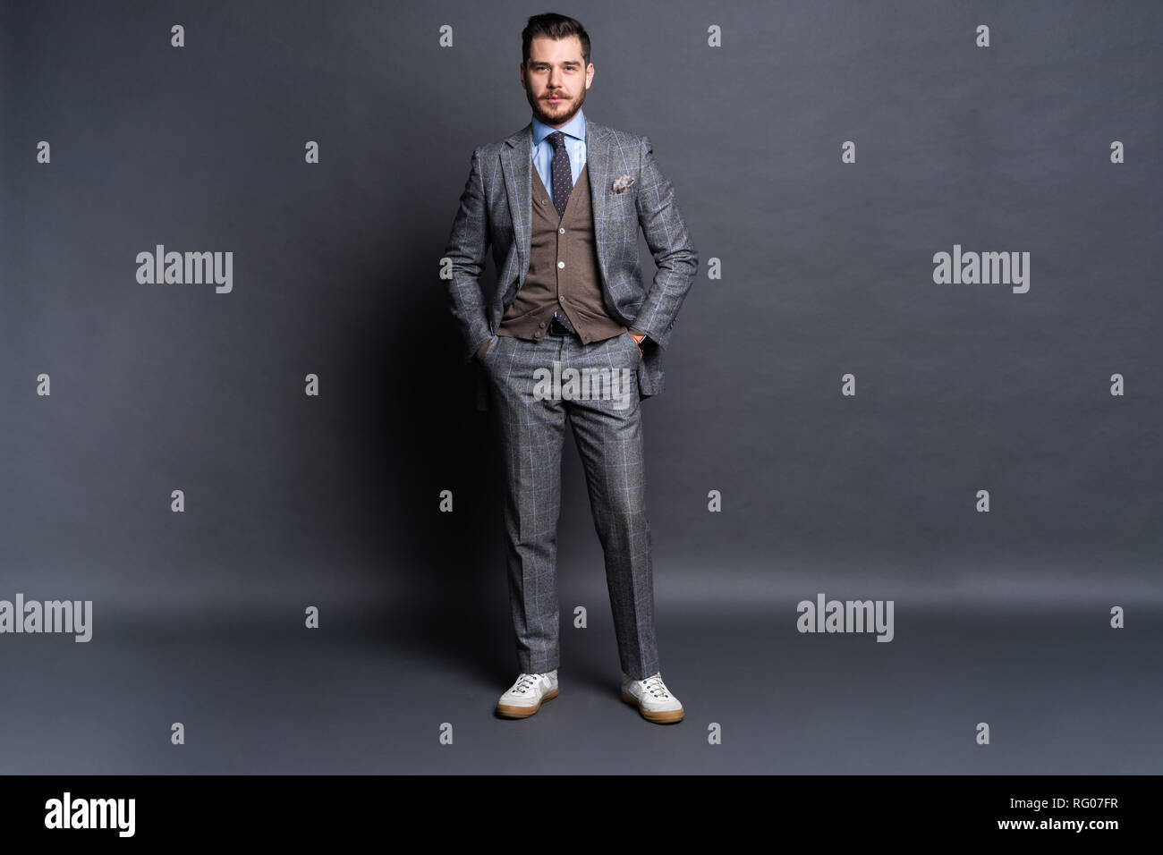 Full length portrait of a fashion male model over grey background ...