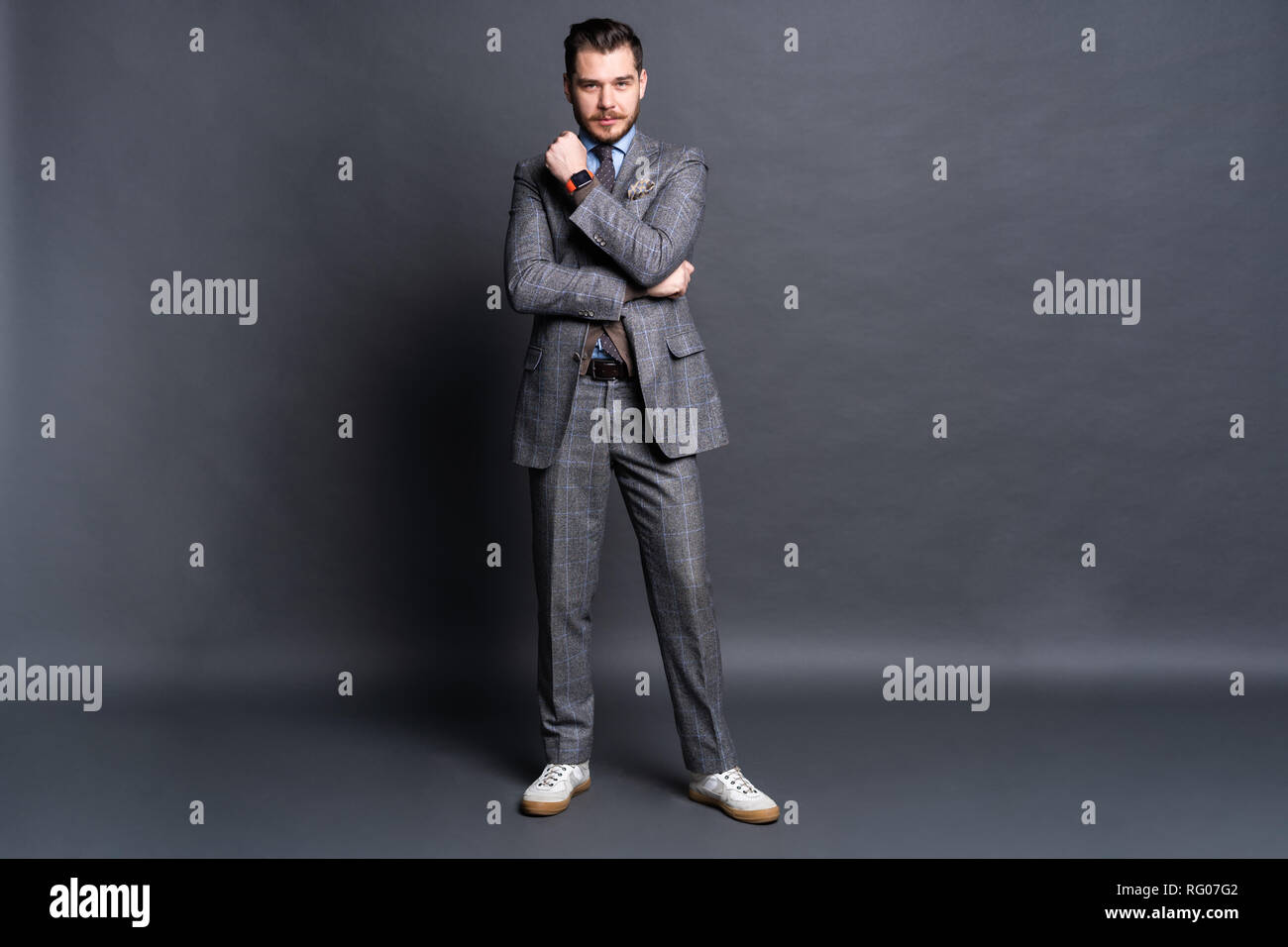 Full length portrait of a fashion male model over grey background ...