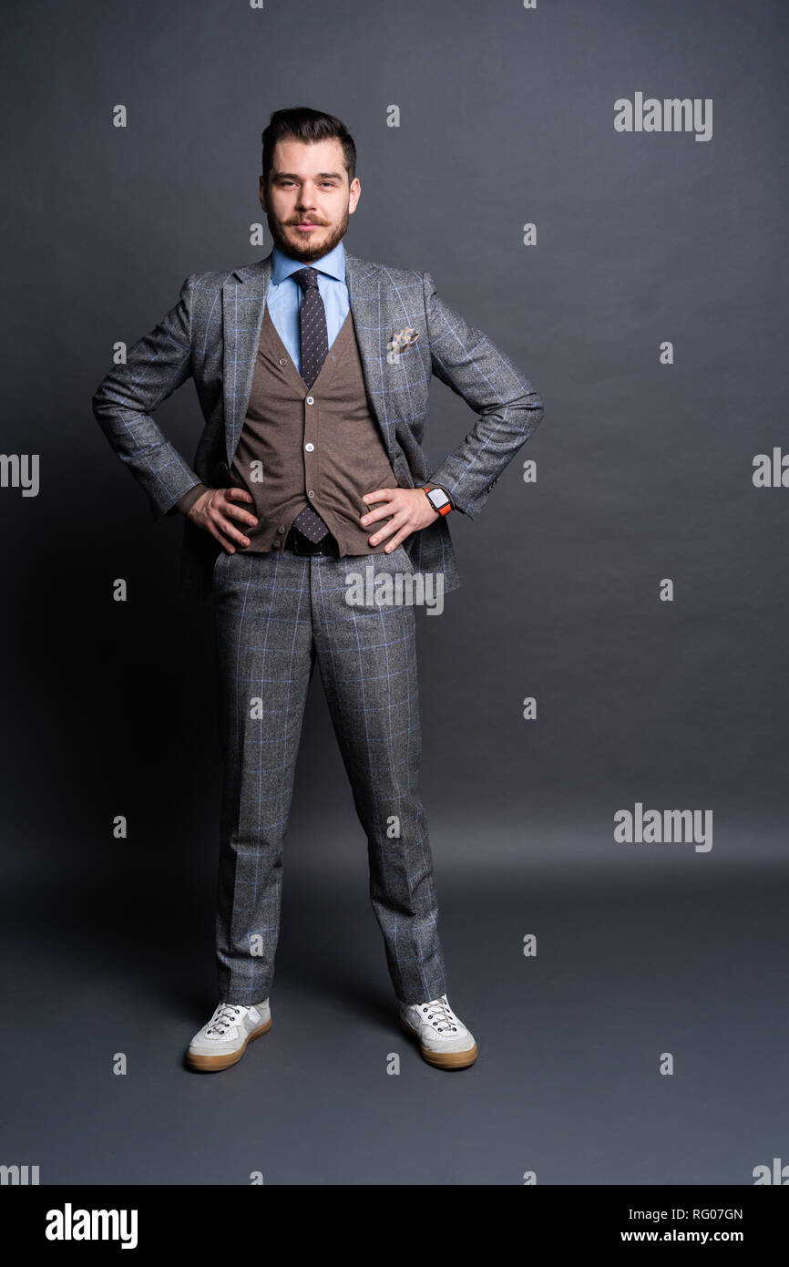 Full length portrait of a fashion male model over grey background ...