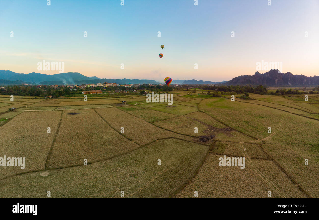 Aerial: Vang Vieng backpacker travel destination in Laos, Asia. Sunset ...