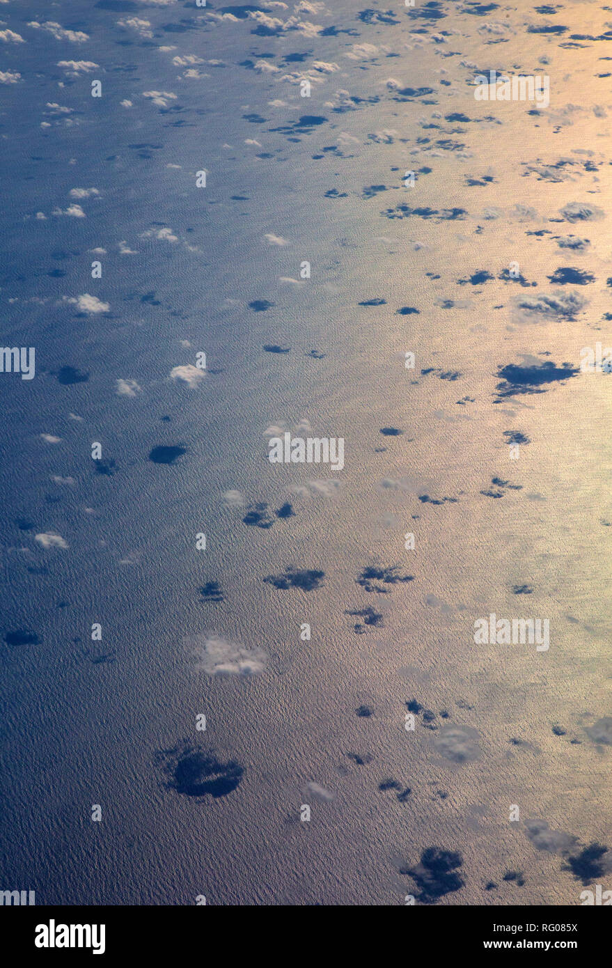 Aerial view of clouds over ocean, cloudscape top view from airplane ...