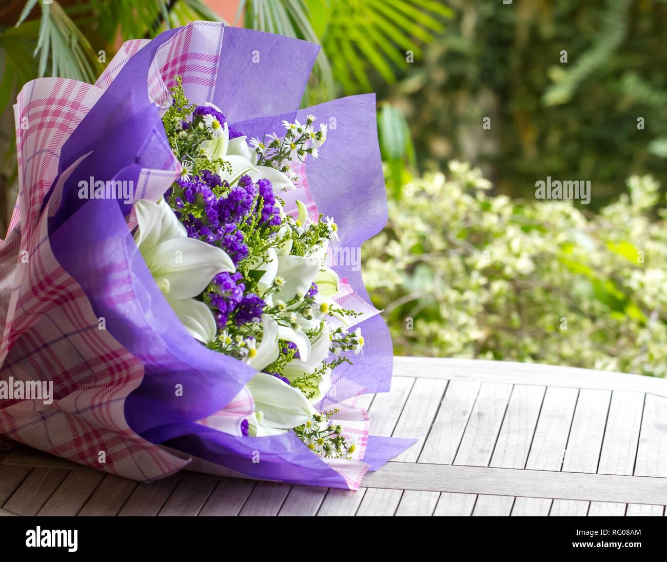 Bouquet of flowers consists of lilies and forget me nots Stock Photo ...