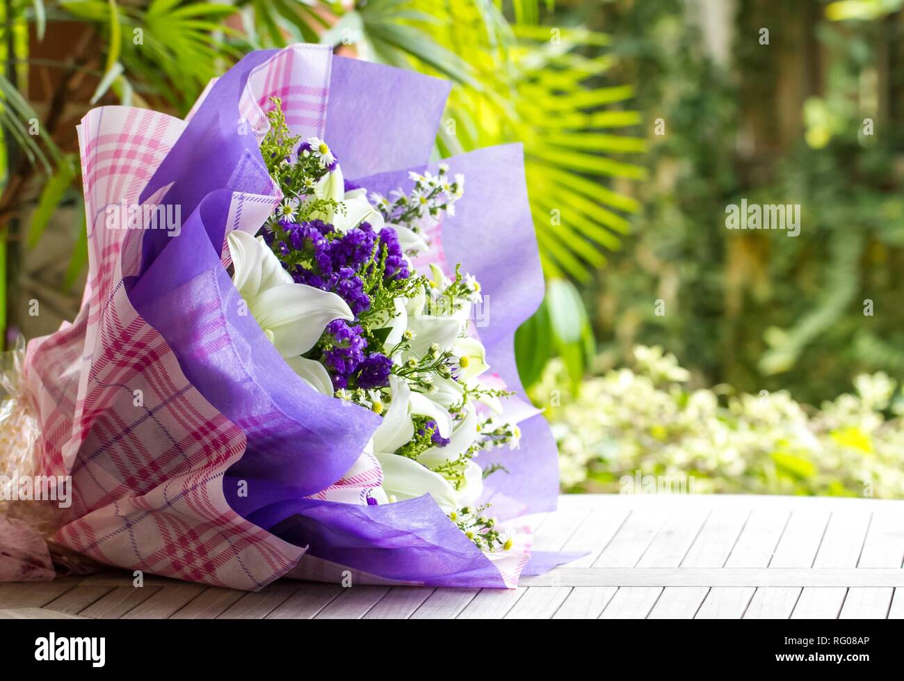 Bouquet of flowers consists of lilies and forget me nots Stock Photo ...