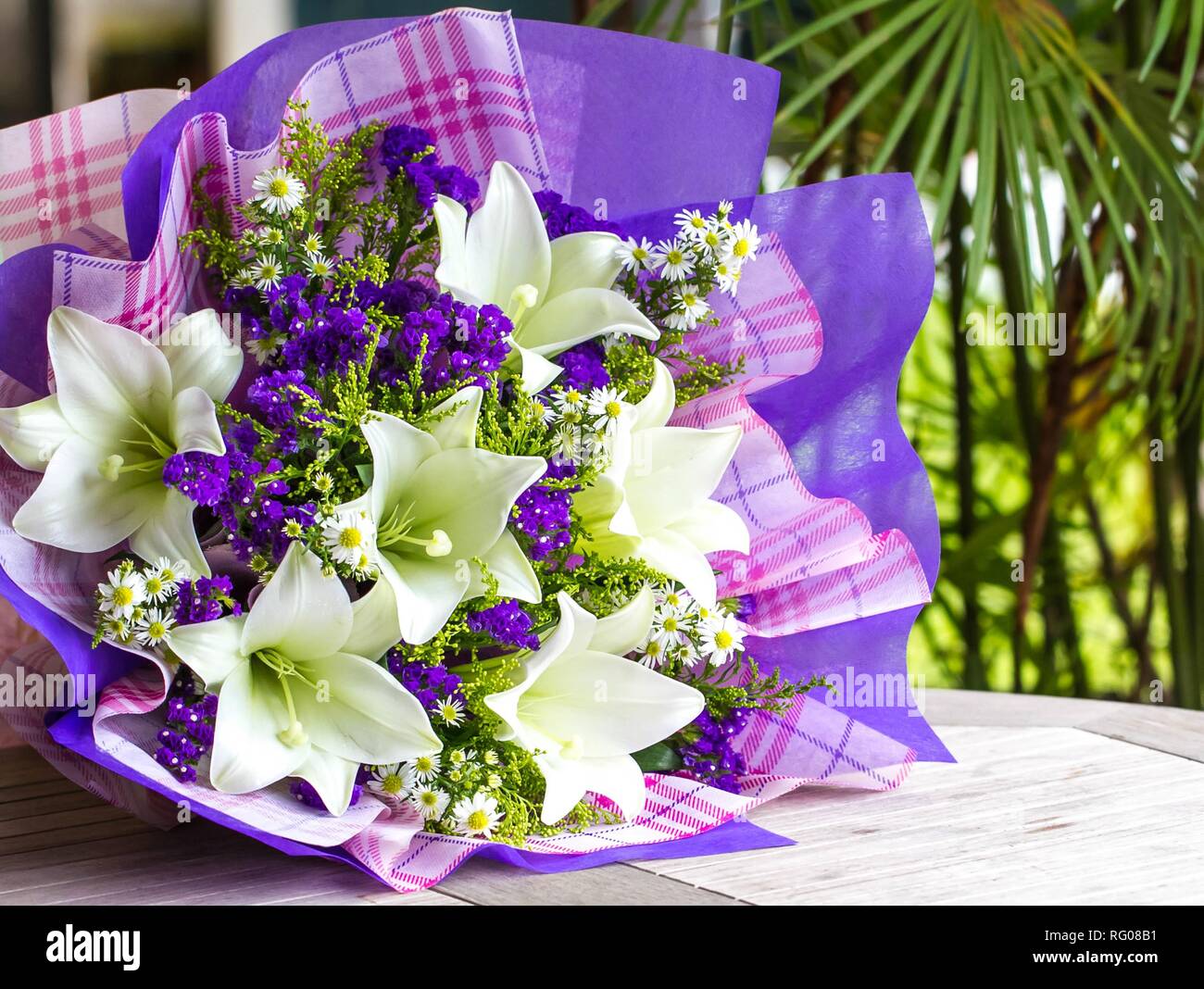 Bouquet of flowers consists of lilies and forget me nots Stock Photo ...