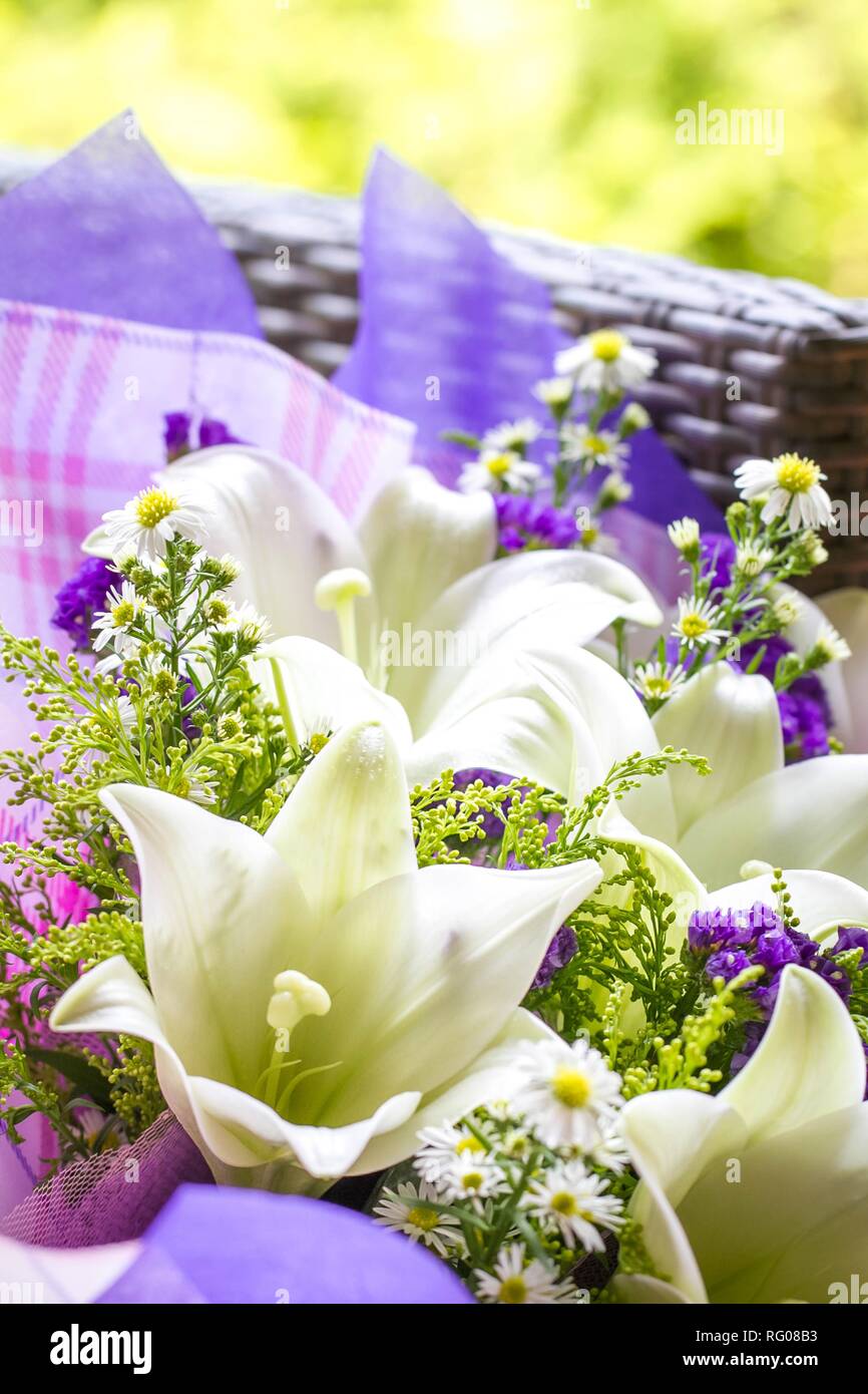 Bouquet of flowers consists of lilies and forget me nots Stock Photo ...