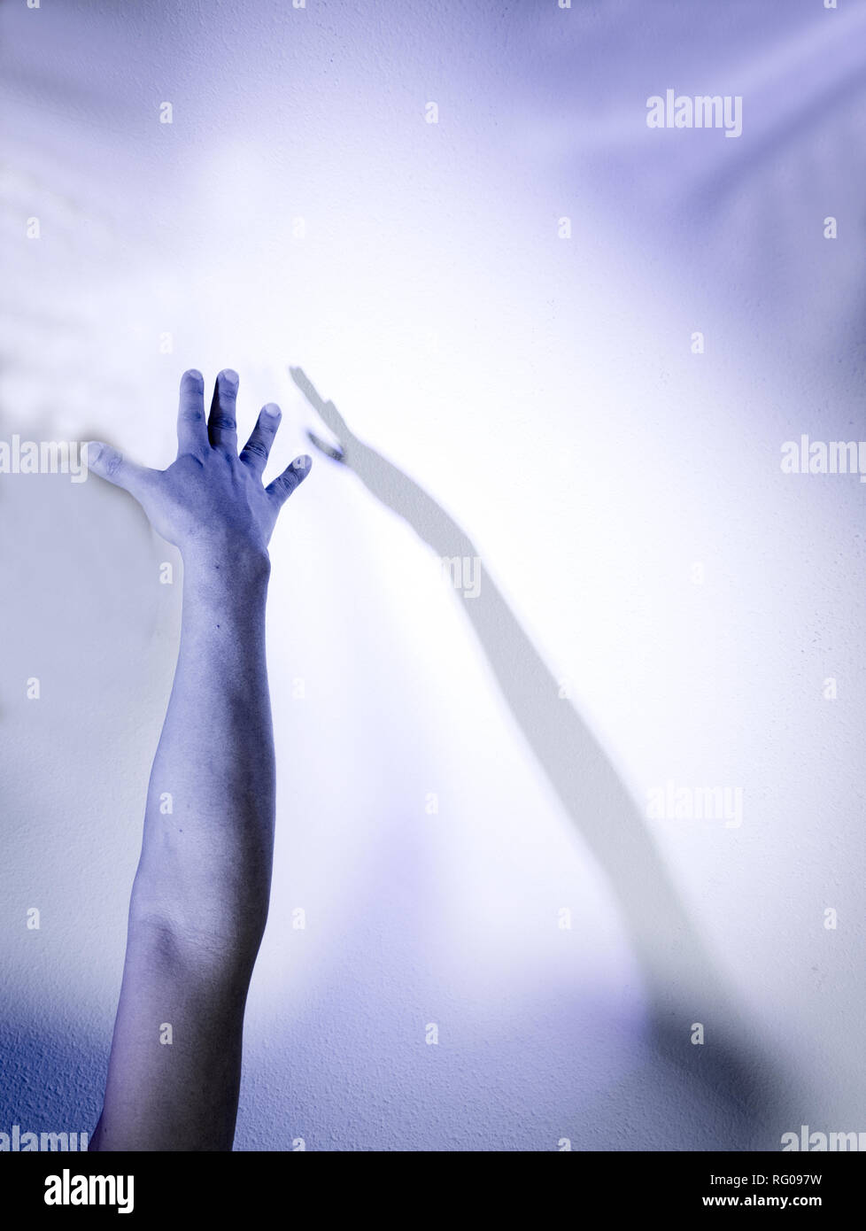 Extended arm with shadow in color, feeling of loneliness Stock Photo ...