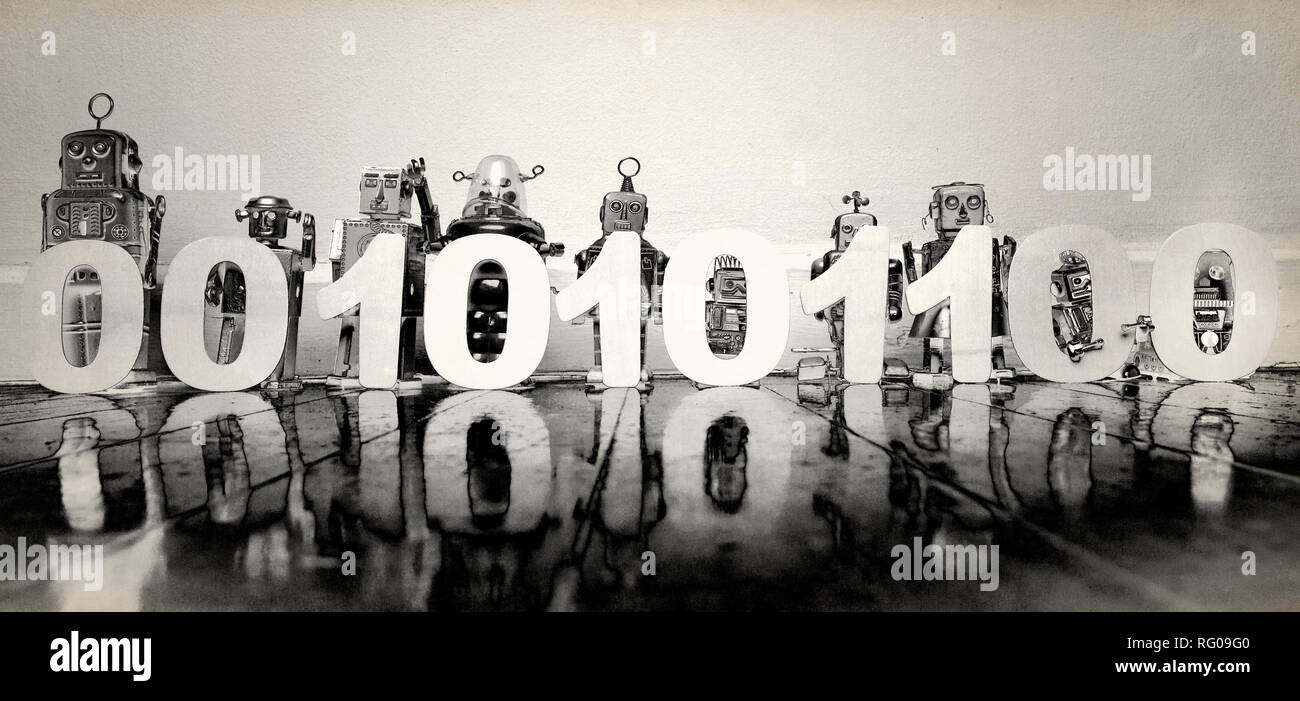 retro robots holding up 0 and 1,s binary code numbers on a old woooden ...