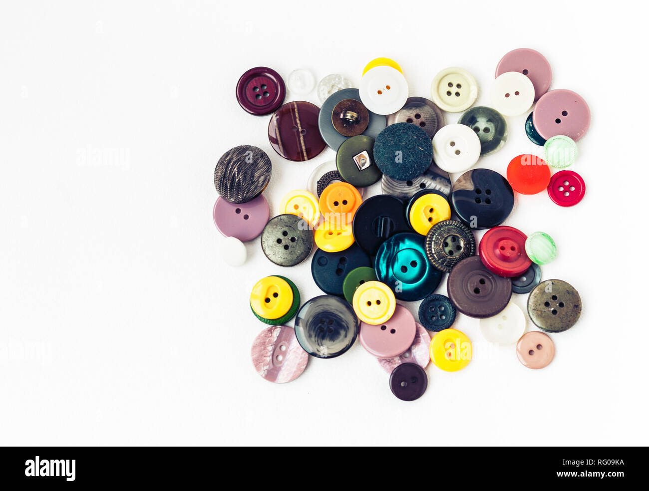 Colorful sewing buttons on white background closeup with copy space for ...