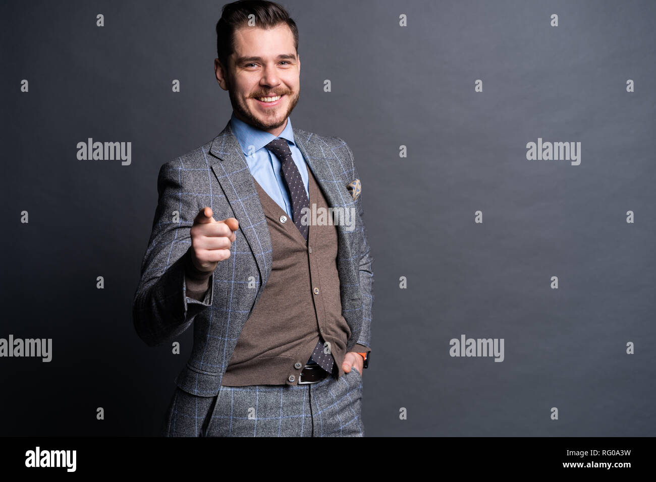 Portrait of young man pointing with his finger Stock Photo - Alamy