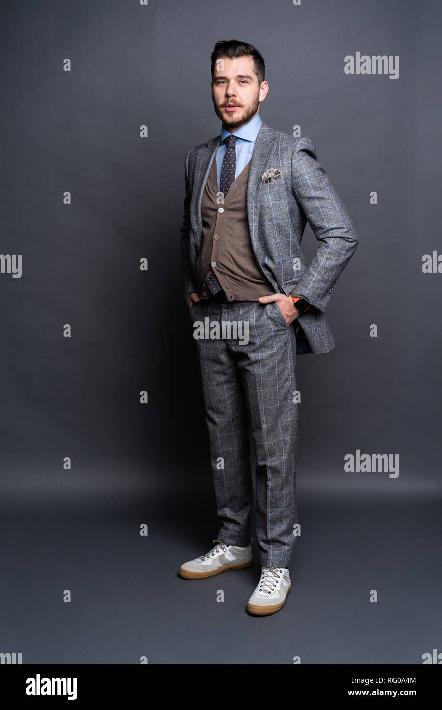 Full length portrait of a fashion male model over grey background ...