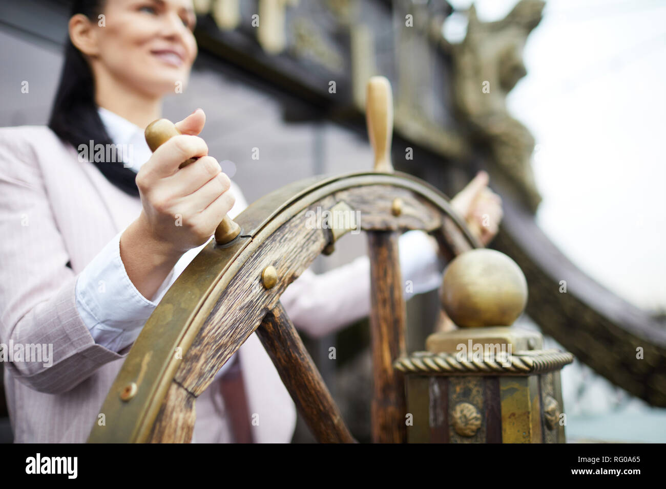 Female ship captain steering boat hi-res stock photography and images ...