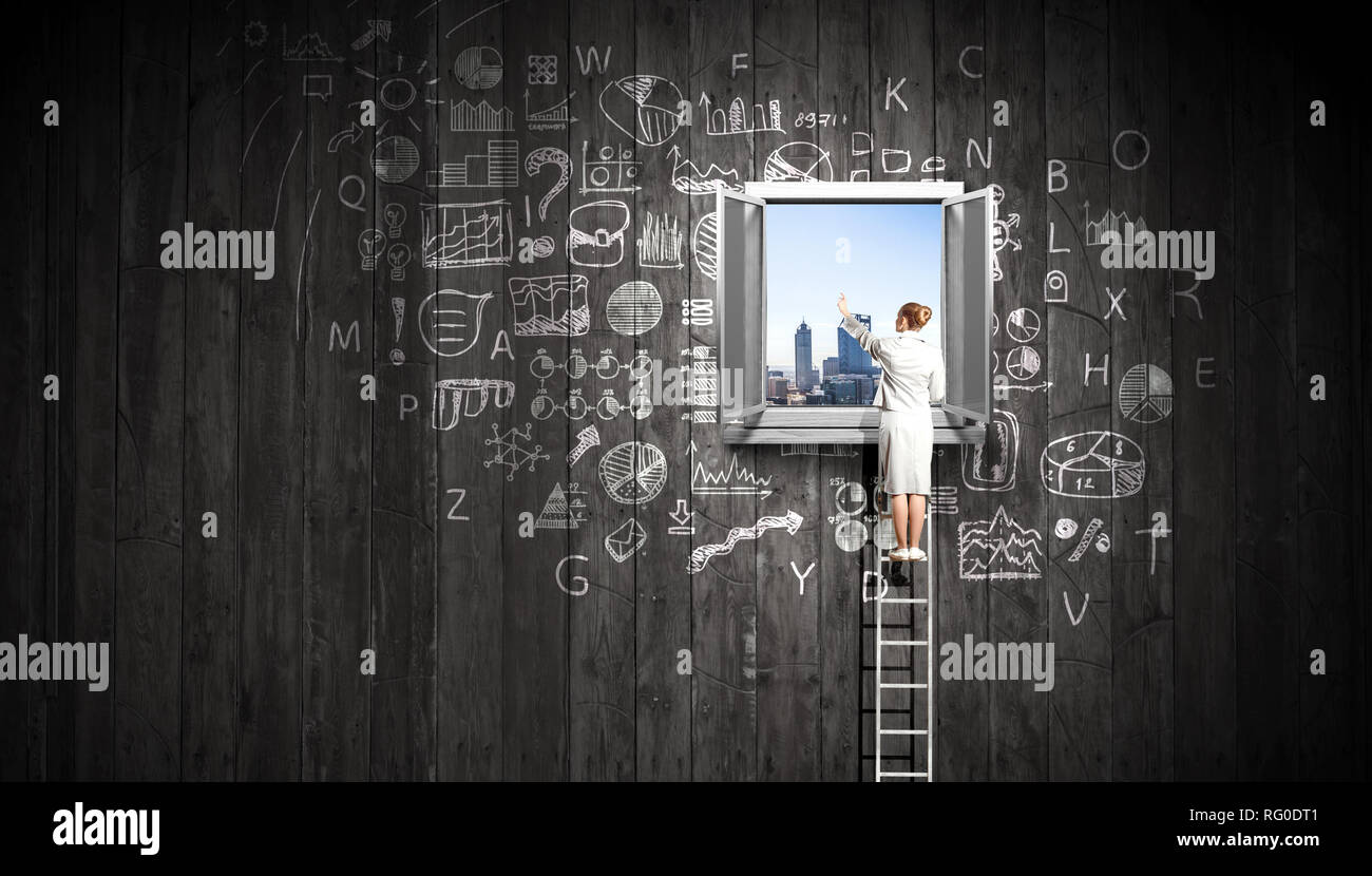 Businesswoman standing on ladder and reaching up opened window in wall ...