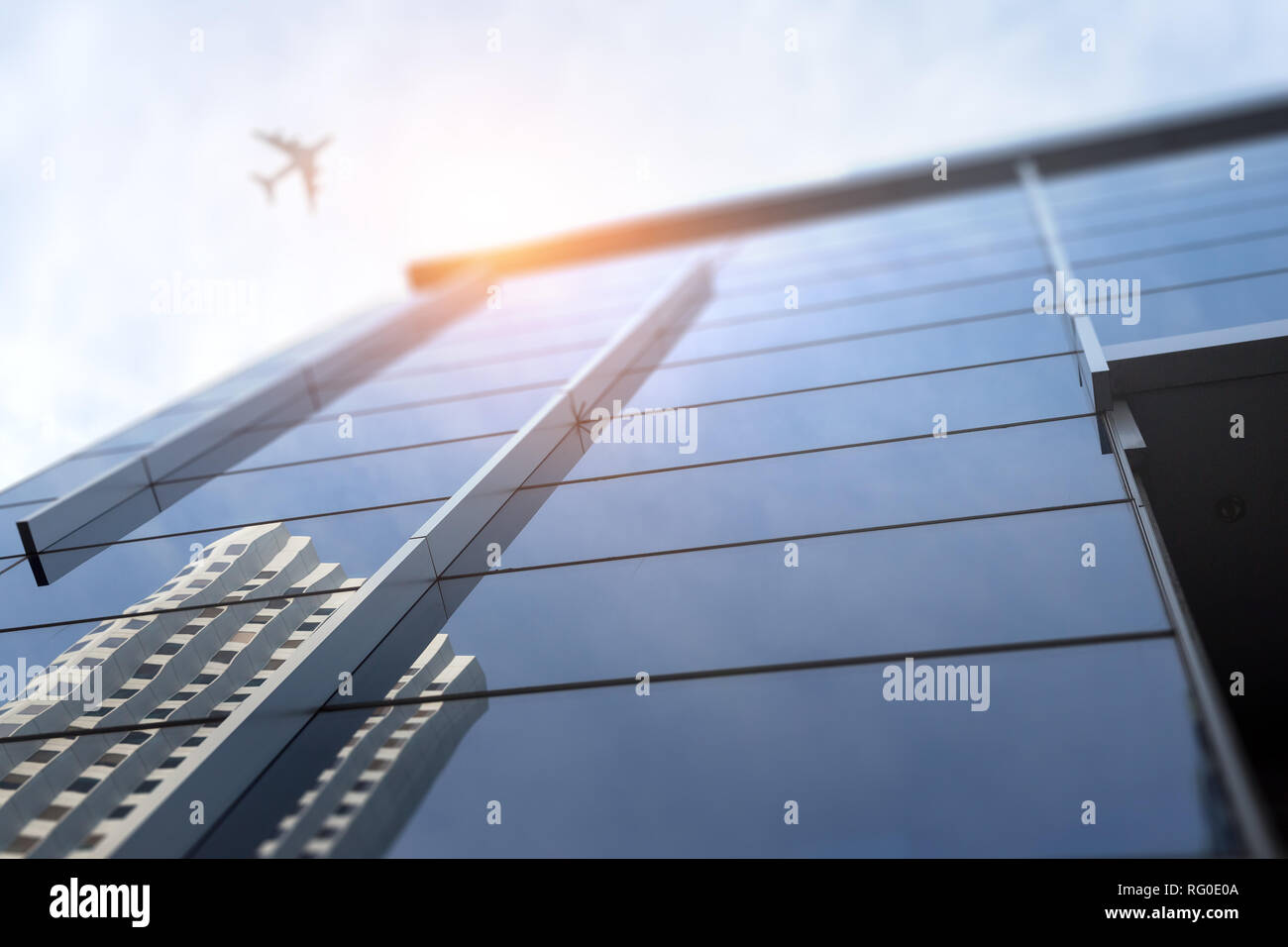 Bottom angle view of airplane in sky over city buildings Stock Photo ...