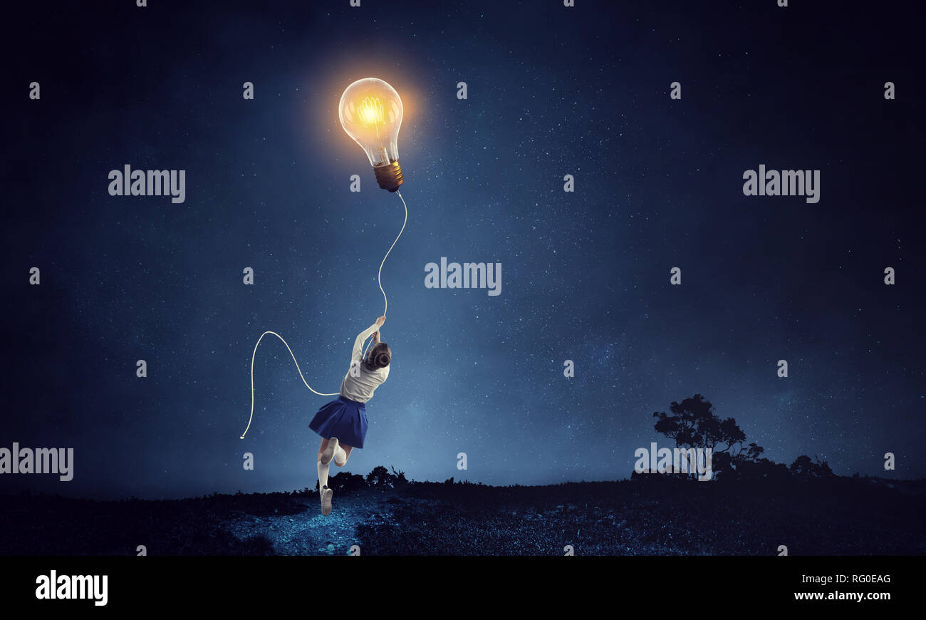 Child and glowing light bulb as concept for education. Mixed media ...