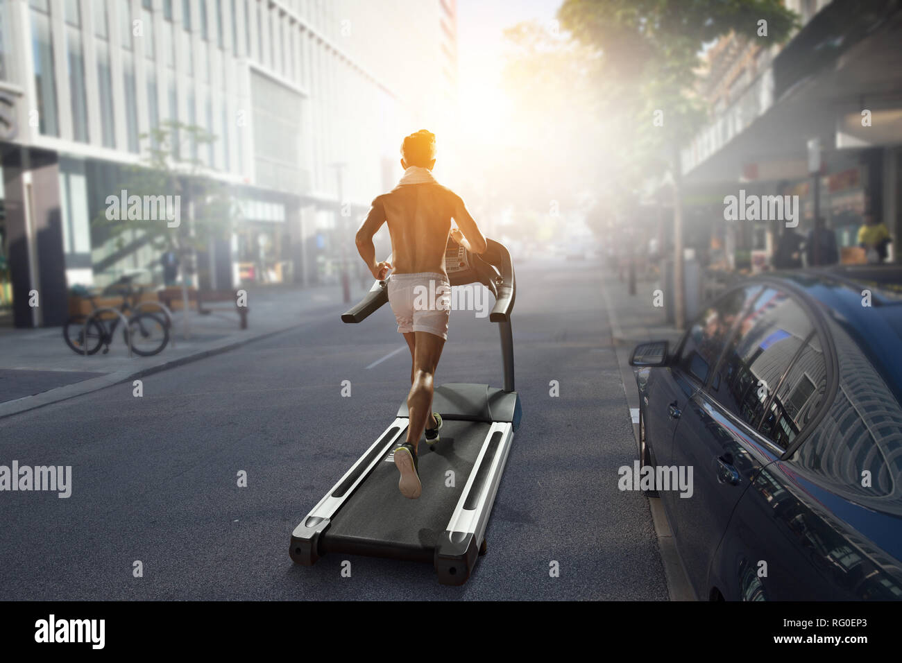 Back view of man athlete running on treadmill. Mixed media Stock Photo ...