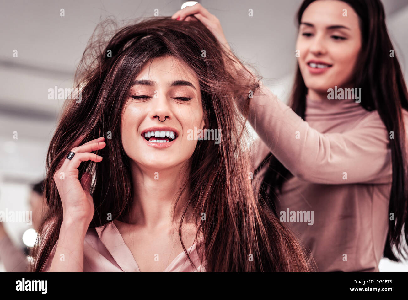 Portrait of a beautiful woman touching her hair Stock Photo - Alamy