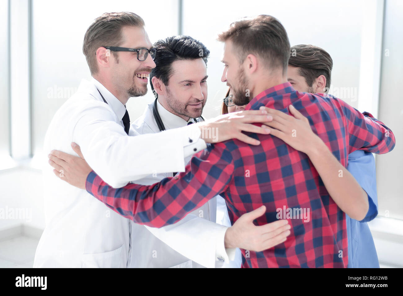 Merry cheerful doctors standing together Stock Photo - Alamy