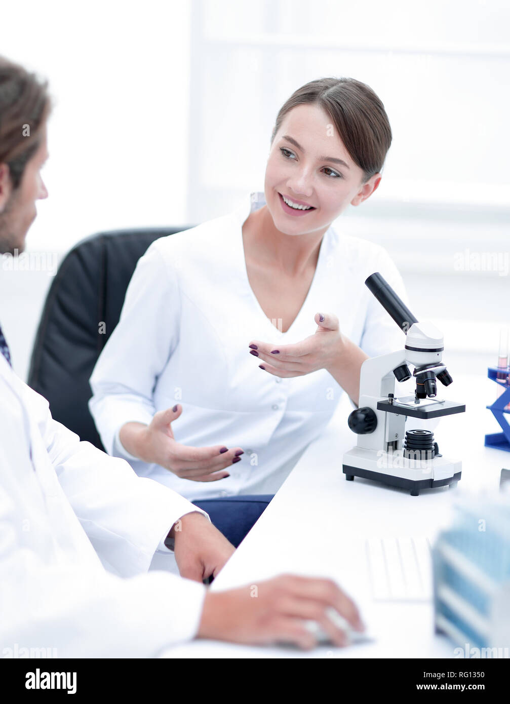 Side view of two scientists conducting a chemical experiment Stock ...