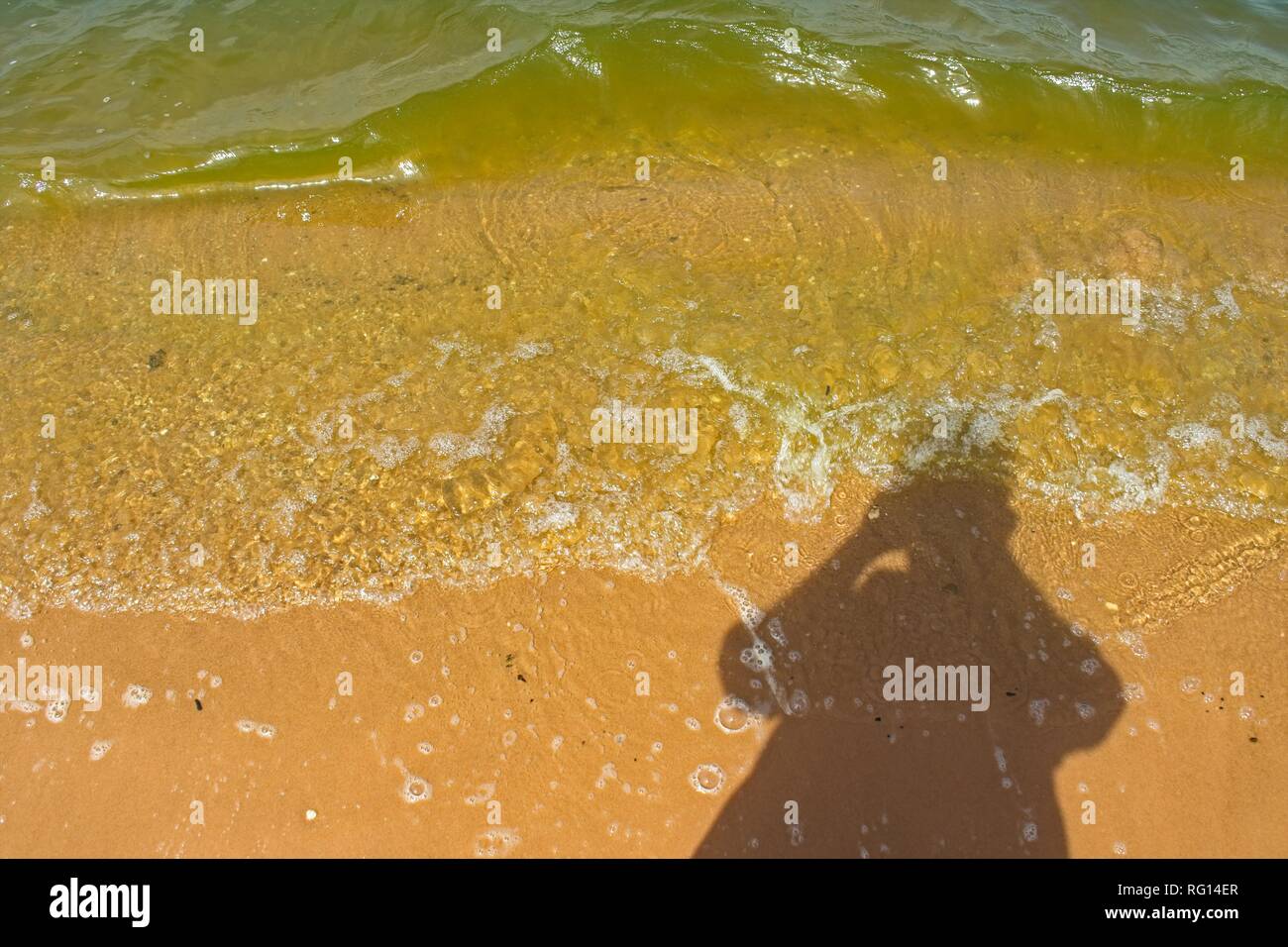 Shadow on beach and wave Stock Photo - Alamy
