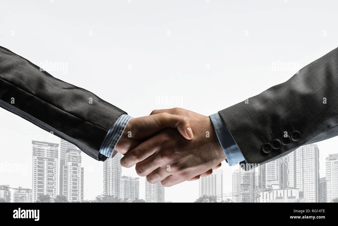 Business handshake as idea for unity and cooperation or greeting. Mixed ...