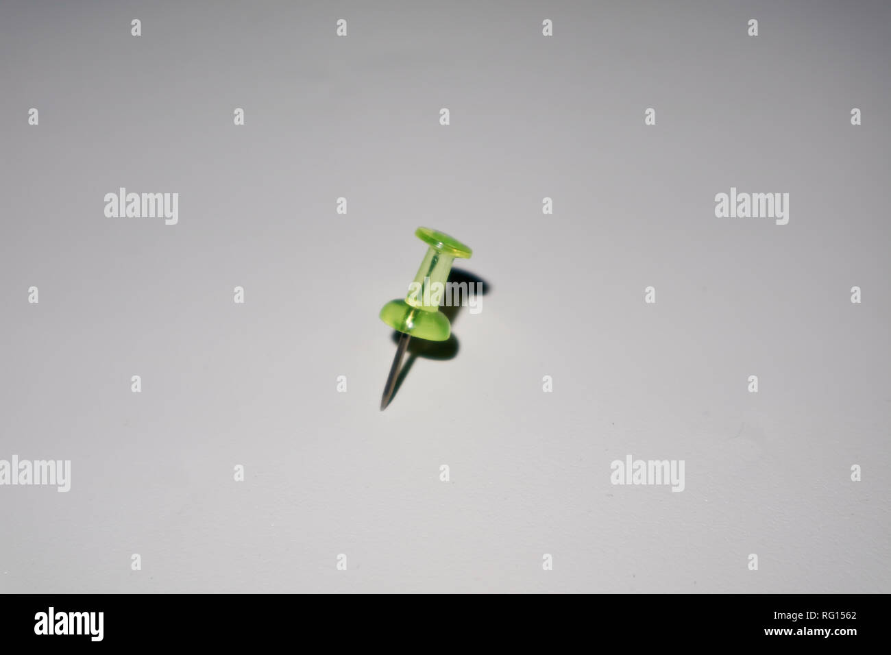 pin sticked in white background Stock Photo - Alamy