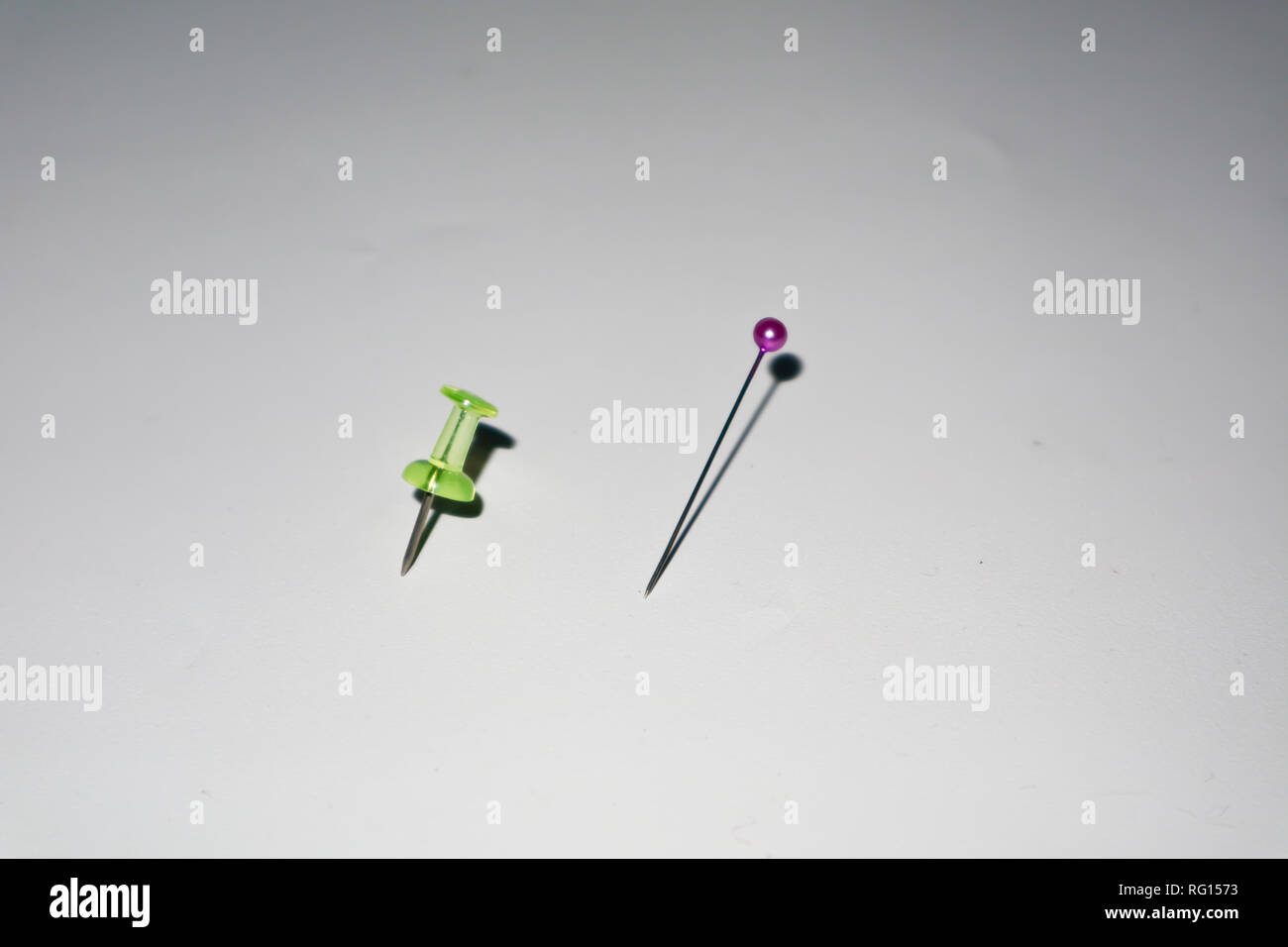 pin sticked in white background Stock Photo - Alamy