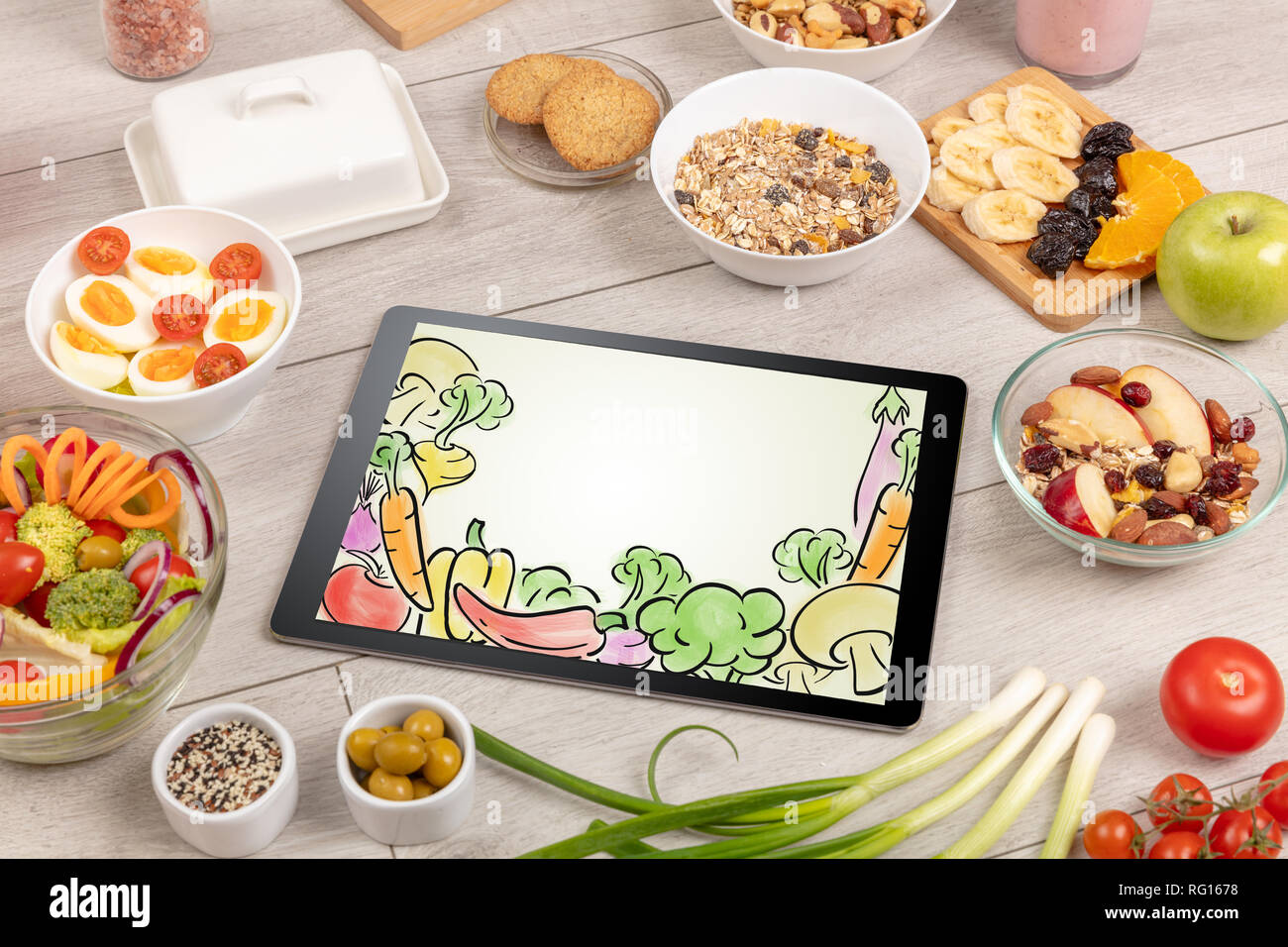 Healthy food composition with tablet Stock Photo - Alamy