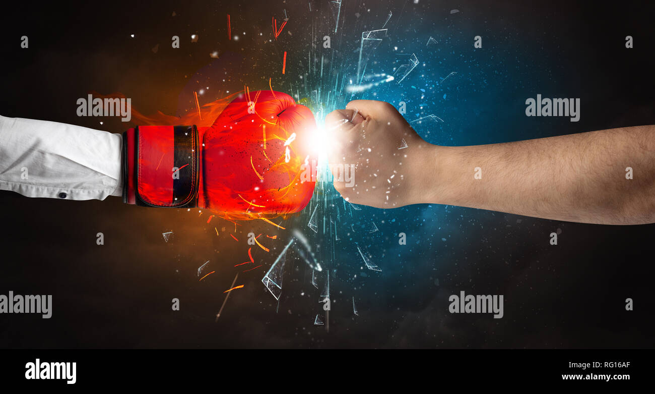Two hands fighting and breaking glass into small pieces with fire and ...