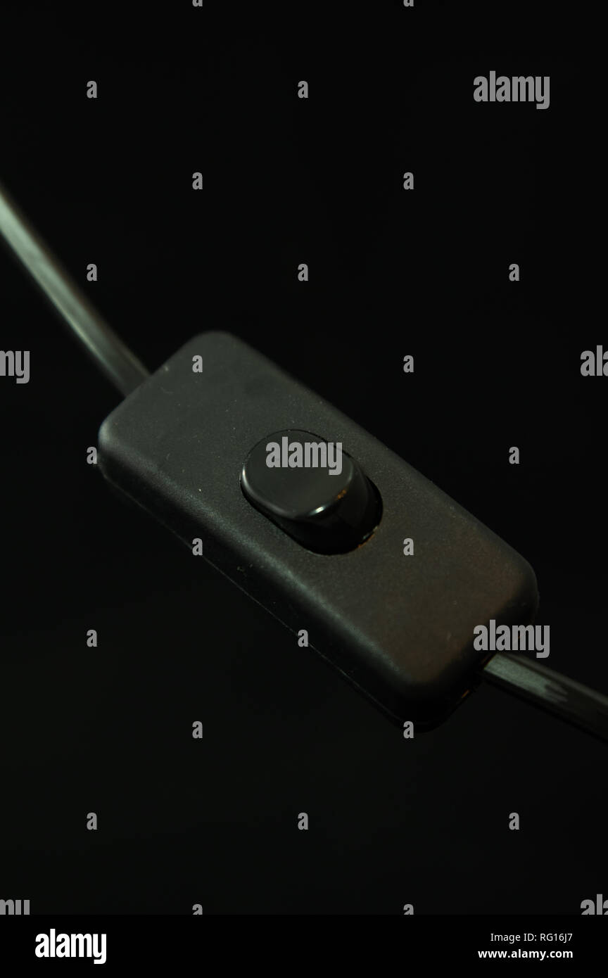 black table lamp switch on black background isolated Stock Photo - Alamy