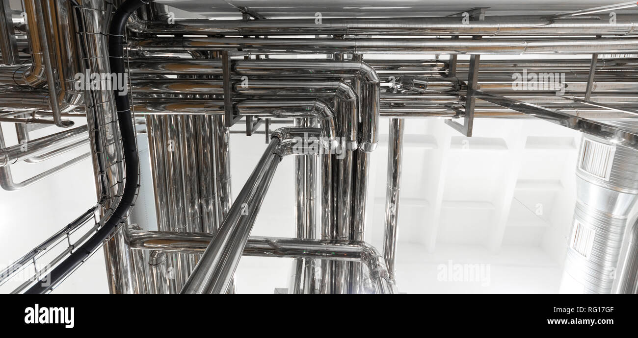 Steel pipelines and cables in factory interior as nuclear industry ...