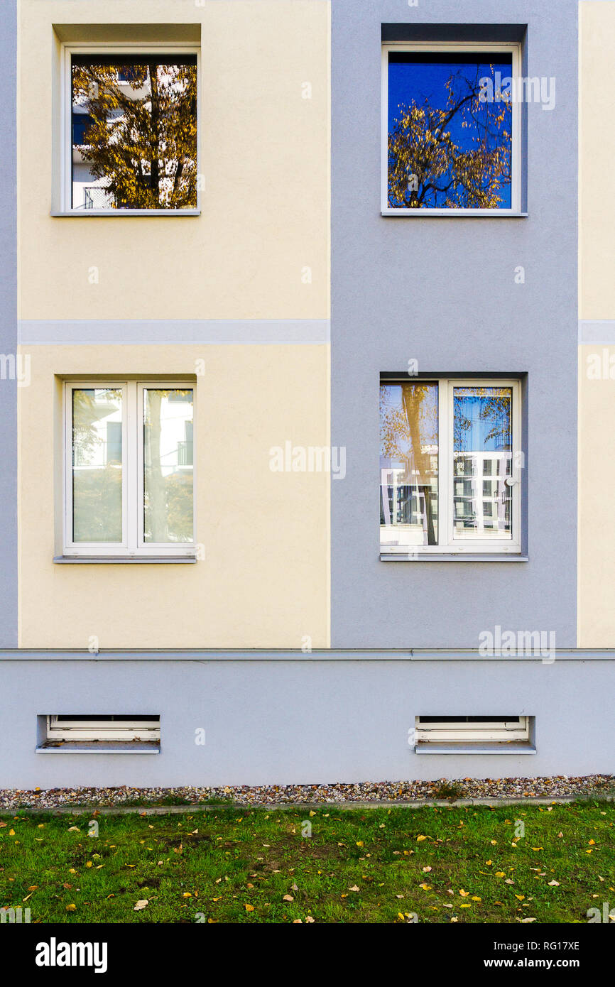 Modern wall with some windows and a grass. Architectural detail ...