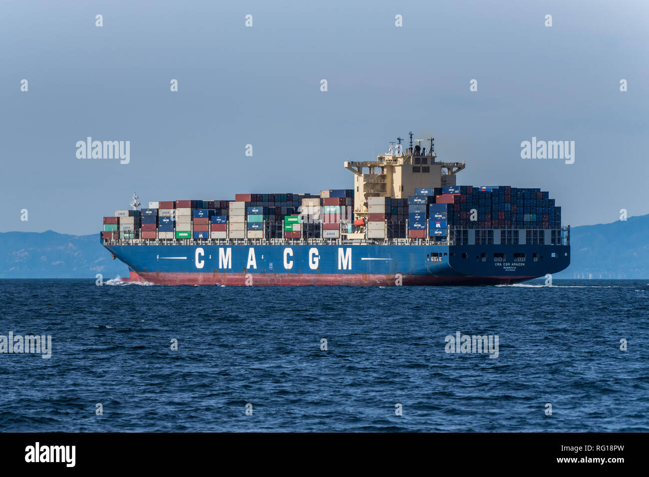 Enormous cargo ship full of shipping containers passing through the ...