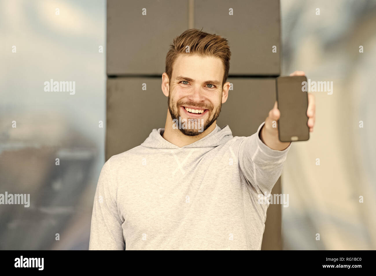 Showing his brand new smart phone. Man beard with smartphone, urban ...