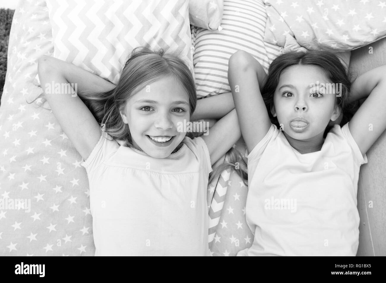 Best friends forever. Girls children lay on bed with cute pillows top ...