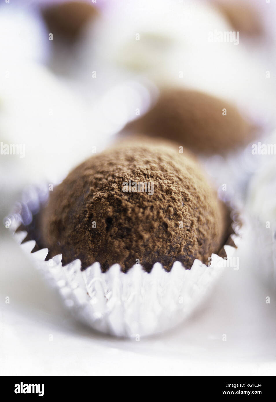 Dark chocolate truffle in foil case Stock Photo - Alamy