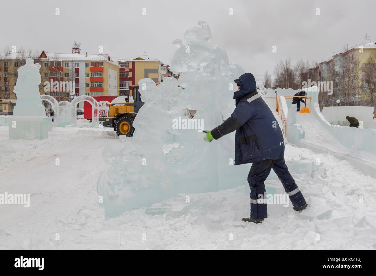 Portrait of a worker engaged in arranging an ice town Stock Photo - Alamy