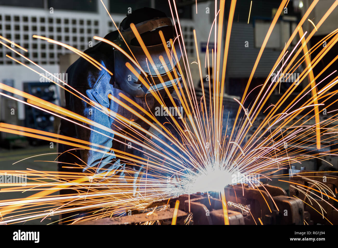 Industrial worker is welding in factory Stock Photo - Alamy