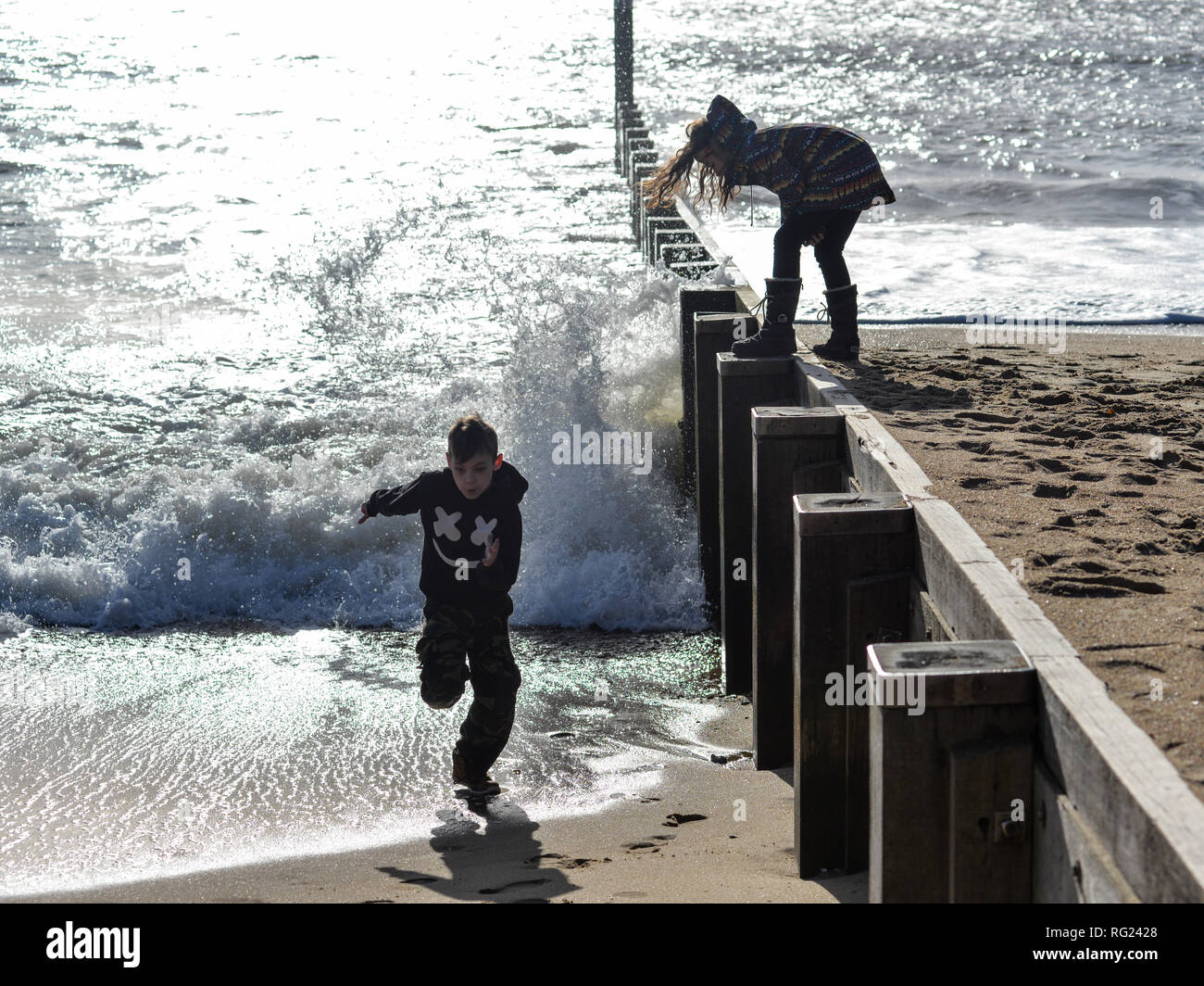 Children playing in waves hi-res stock photography and images - Alamy