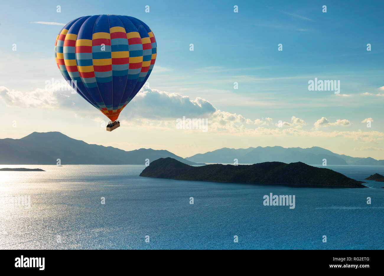 Colorful hot air balloon fly over the blue sea Stock Photo - Alamy