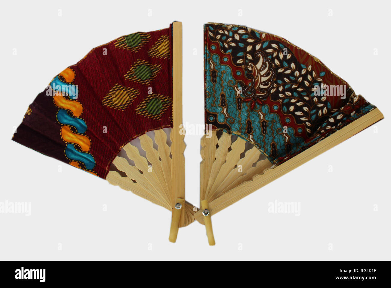 A wooden hand fan in Javanese cloth called batik. Exotic Stock Photo ...
