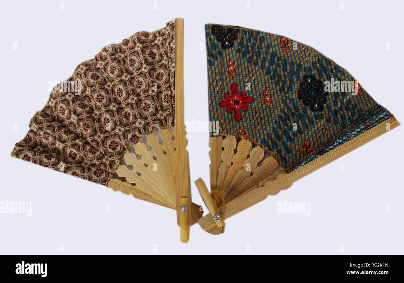 A wooden hand fan in Javanese cloth called batik. Exotic Stock Photo ...