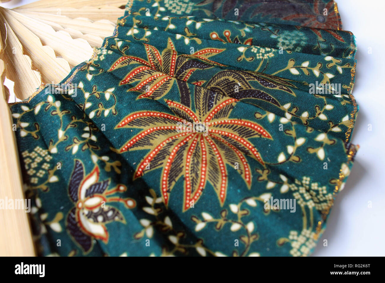 A wooden hand fan in Javanese cloth called batik. Exotic Stock Photo ...