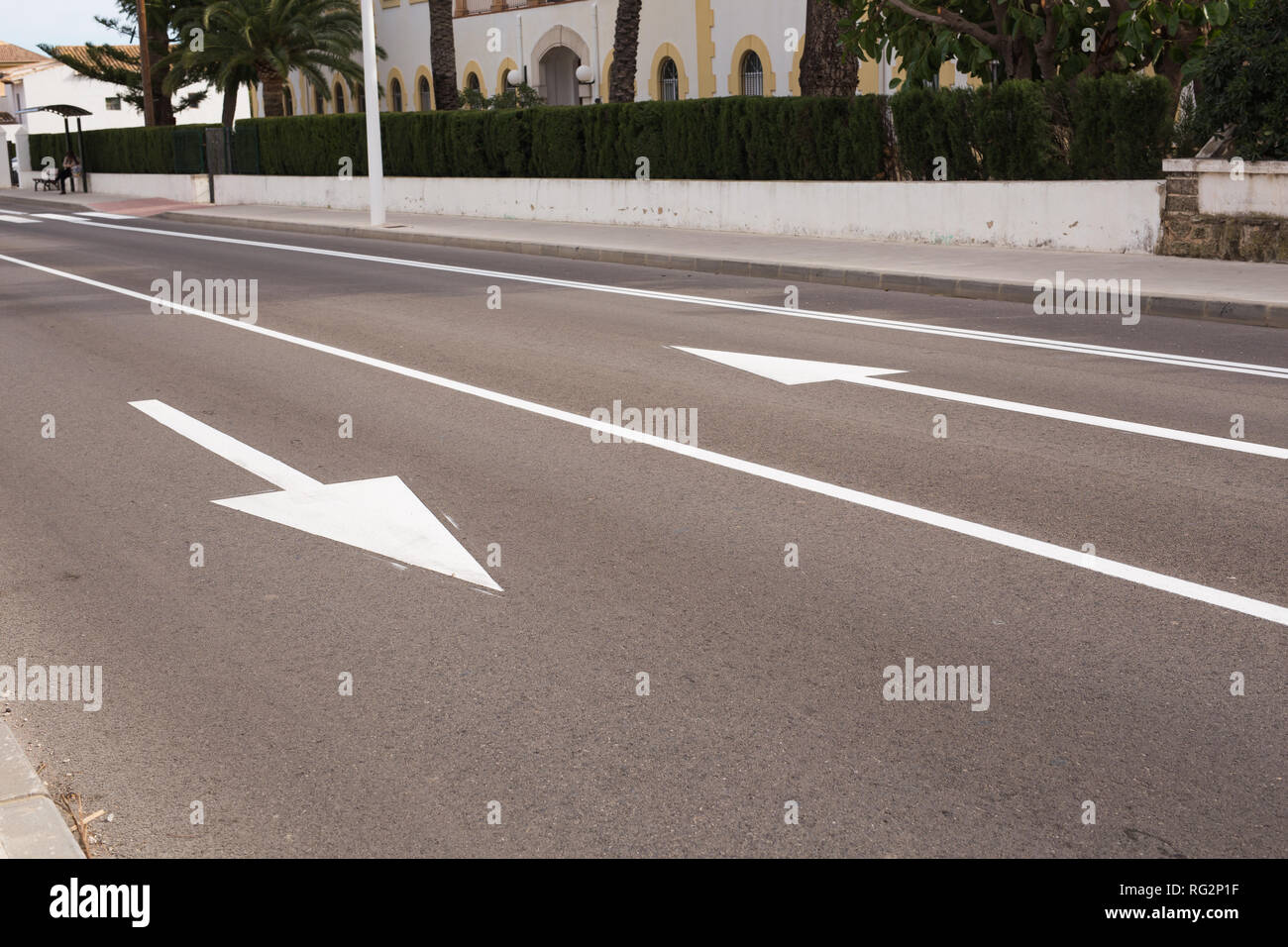 Arrow signs as road markings on a street with two lanes Stock Photo - Alamy
